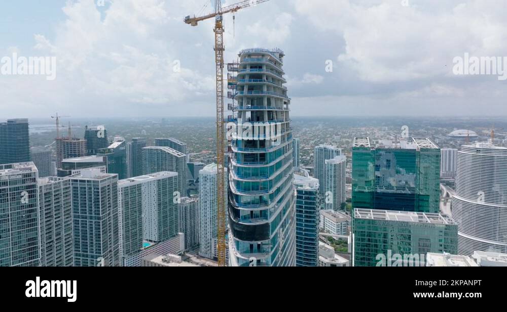 Tall tower crane working on skyscraper construction site. Aerial view ...