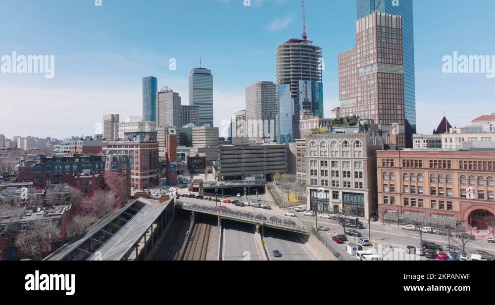 Busy multilane road leading under high rise buildings. Modern downtown ...