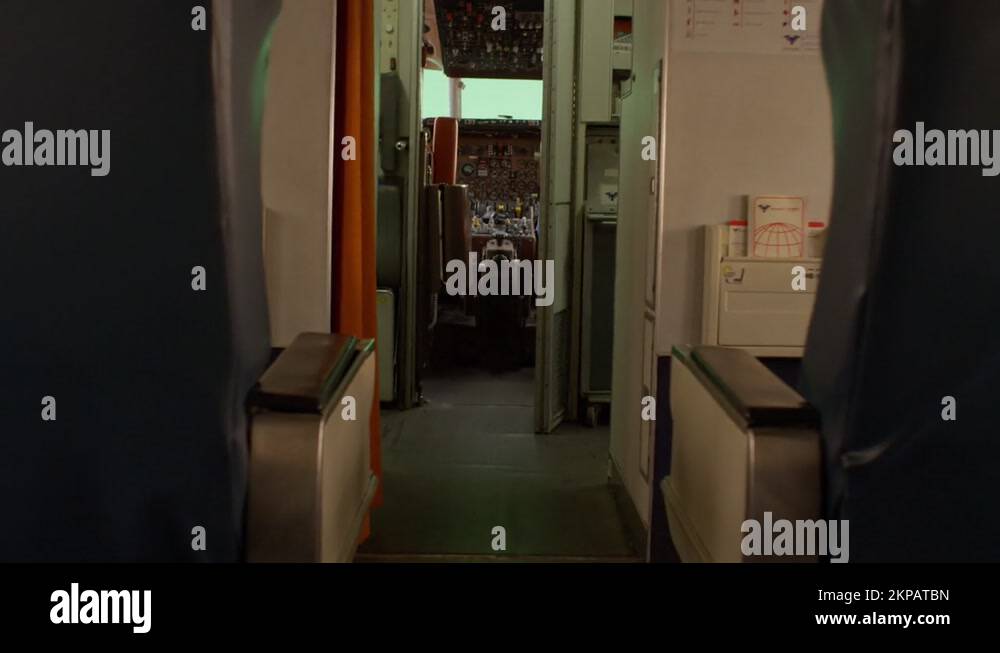Dolly-in of an airplane cockpit with a green screen backdrop outside ...