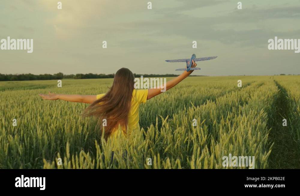 Child girl playing with toy plane. Teenager Girl dreams of flying ...