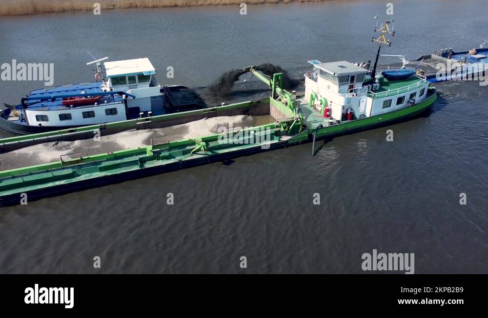 Dredging ship dredges off mud from river bottom to improve the fairway ...