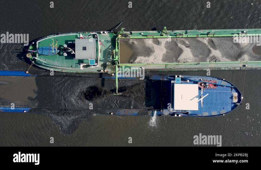 Dredging ship dredges off mud from river bottom to improve the fairway ...