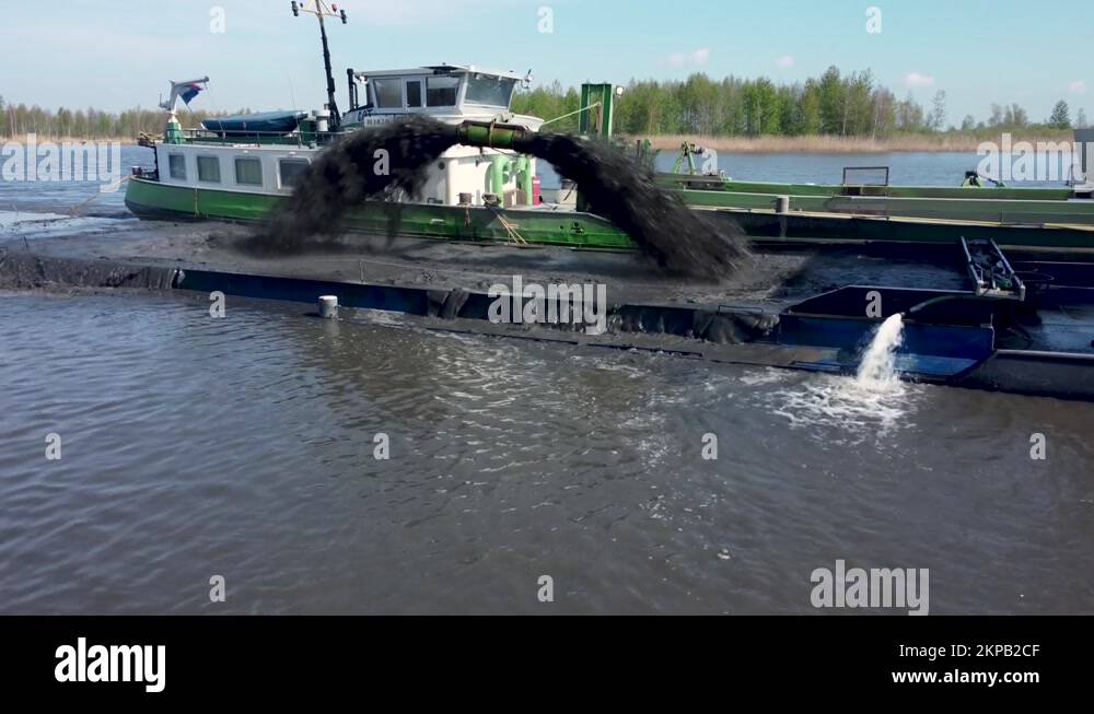 Dredging ship dredges off mud from river bottom to improve the fairway ...