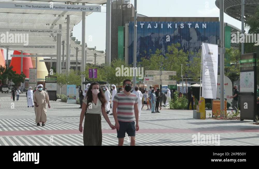 Visitors stroll through the grounds of Dubai Expo 2020 with pavilions ...