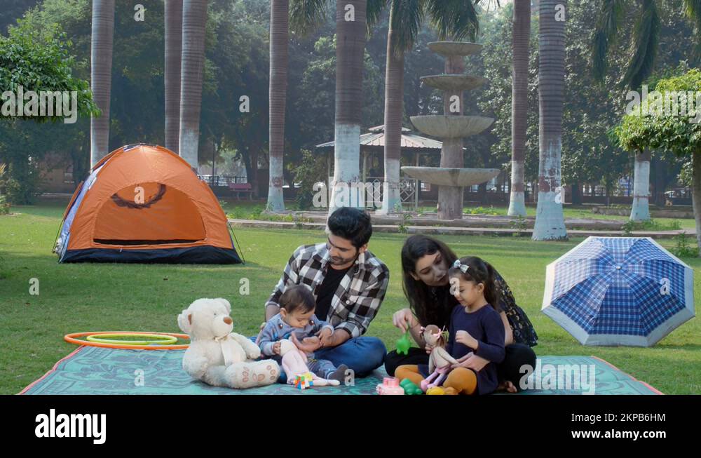 Indian family picnic in a farmhouse - Young parents with their girl and ...
