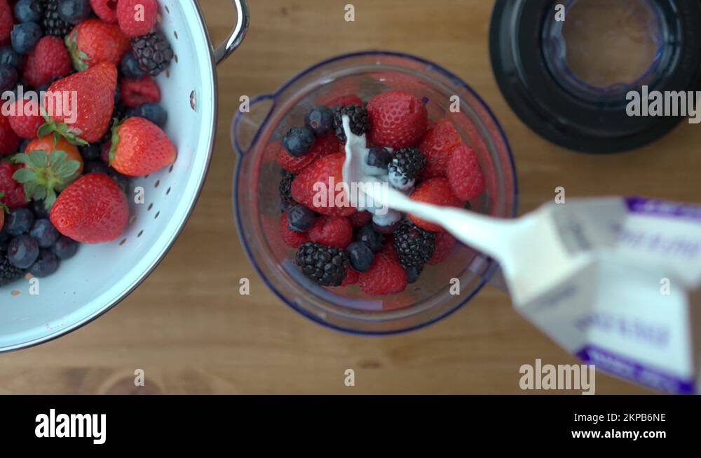 pouring milk into the blender for berry smoothie Stock Video Footage ...