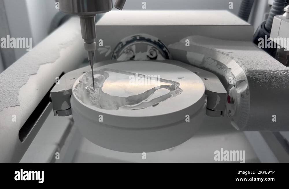 CNC dental milling machine carving out shape of artificial teeth in the ...
