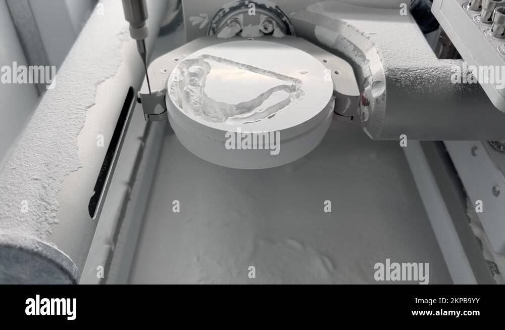 CNC dental milling machine carving out shape of artificial teeth in the ...