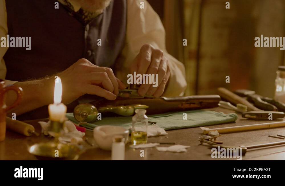 18th century man fitting the lock in a flintlock pistol Stock Video ...