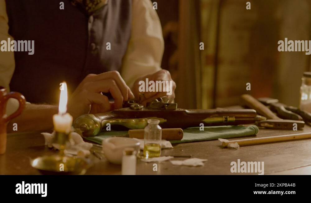 18th century man fitting a flint in the flintlock pistol Stock Video ...