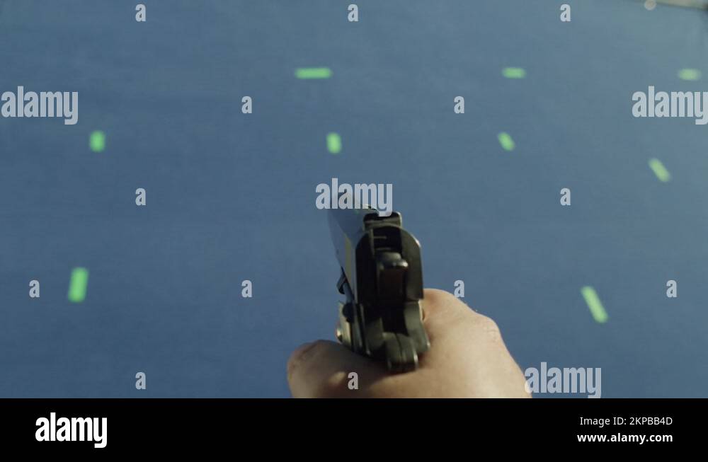 Handgun. Pretending to open fire with a pistol, with a blue screen ...