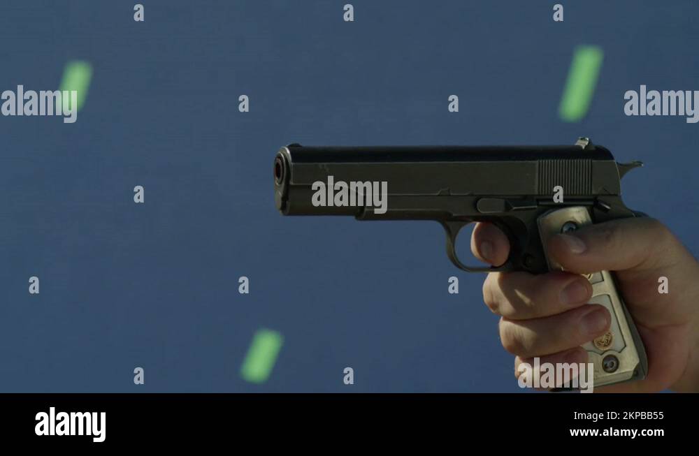 Handgun. Pretending to open fire with a pistol, with a blue screen ...