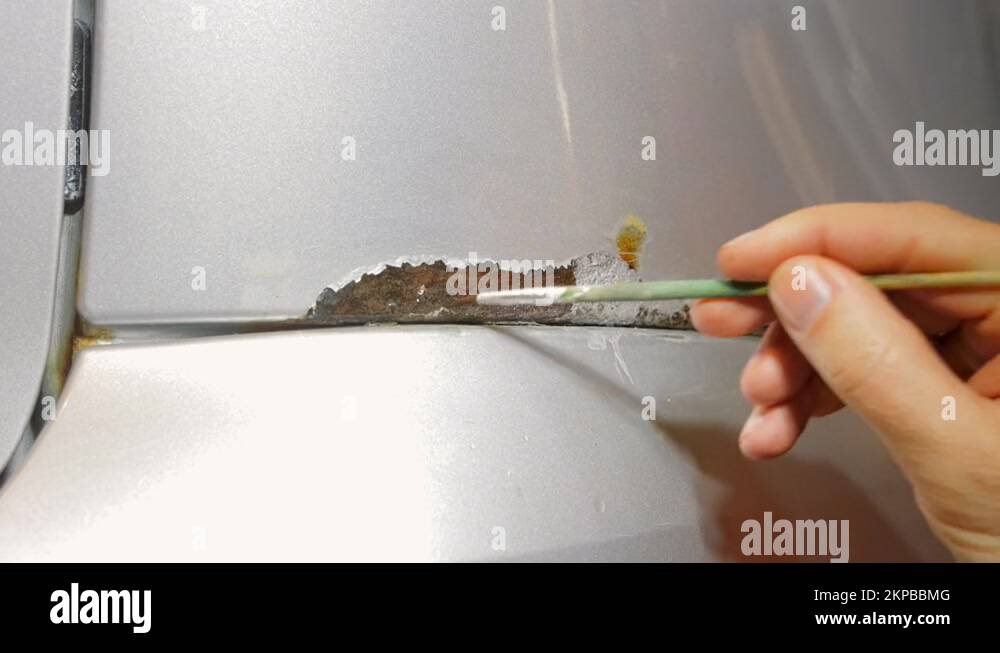 paint rust and corrosion on the car with a brush with a rust converter ...
