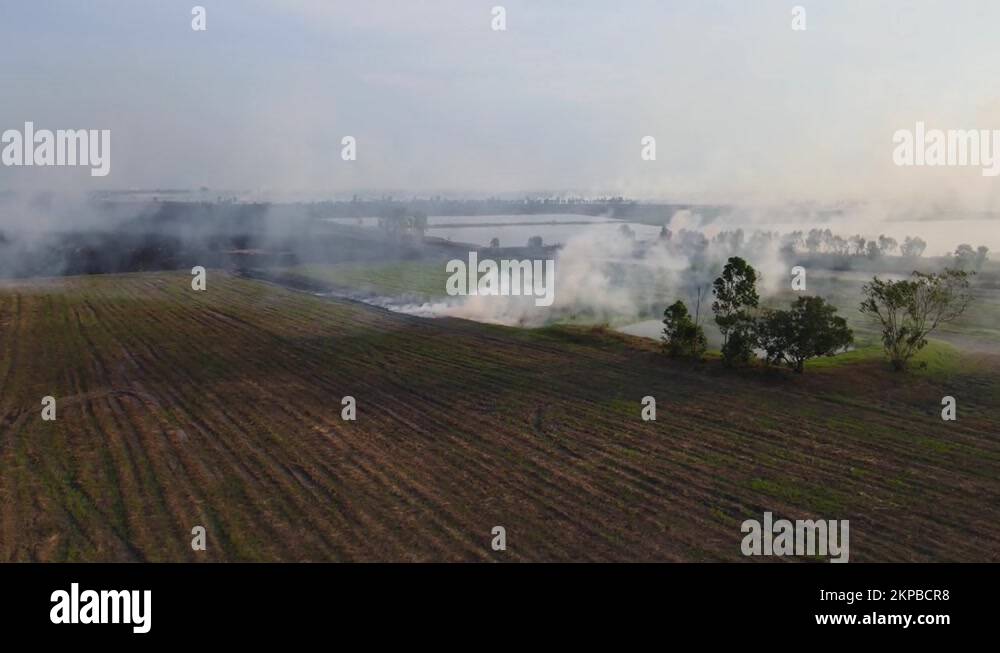 Aerial footage ascending revealing a burning farmland prepared for ...