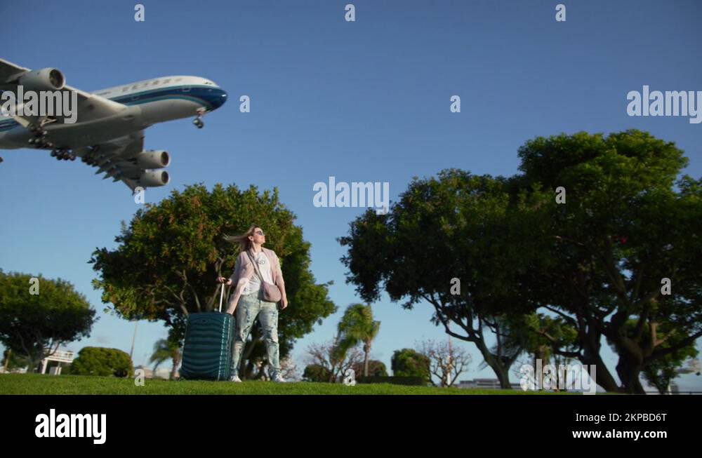 Chinese jumbo jet airplane with tourists landing in blue sunset sky ...