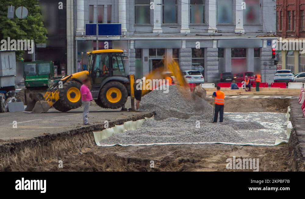 Industrial truck loader excavator moving soil and unloading into a ...