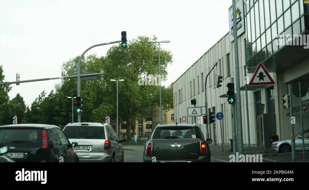 Driving on Kinzigstrasse with Mini Cooper car in front turning right to ...