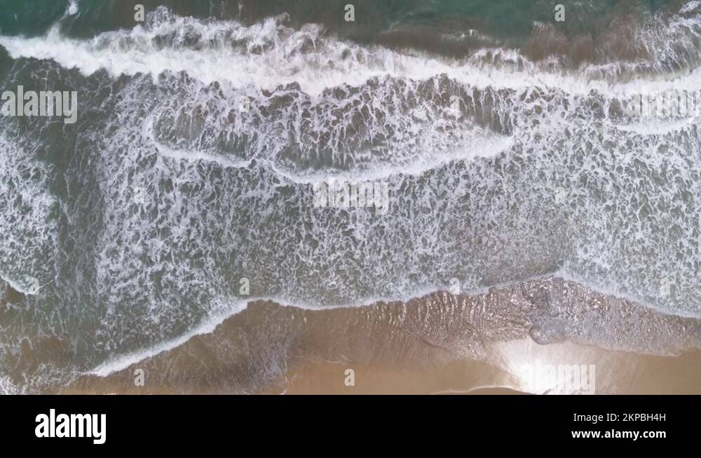Transparent sea wave on the yellow sand of the Cuban beach, top view ...