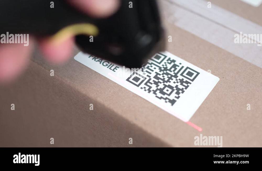 Scanning a QR Code on a Shipping Box With Fragile Warning Sign Stock ...