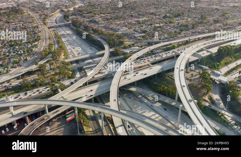Busy traffic on multilevel roads, bridges, ramps, viaducts at sunset ...