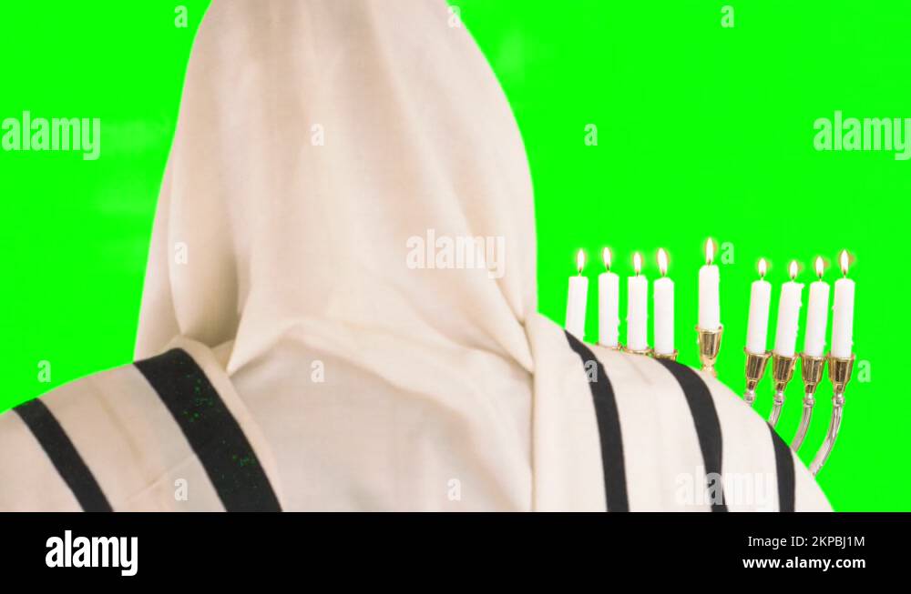 Jewish man praying in front of menorah candles on green screen chroma ...