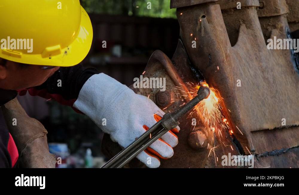 Worker cutting steel with a gas torch. Man cutting steel with propane ...