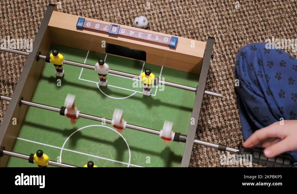 Goal. Table football game with yellow and red players. Family leisure ...