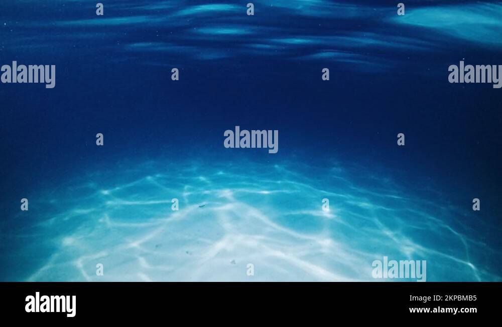 Night sea. Underwater view of the night sea and sandy bottom with wave ...