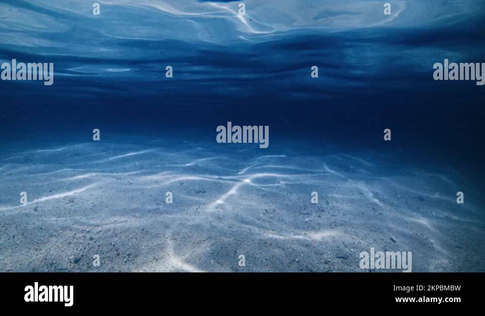 Night sea. Underwater view of the night sea and sandy bottom with wave ...