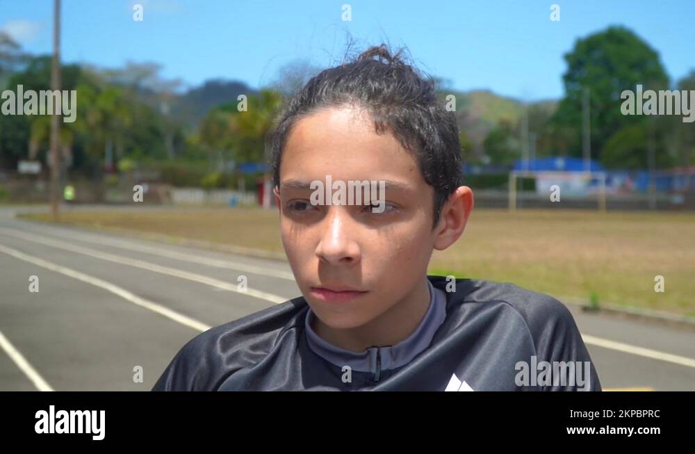 A kid with disability standing still on a wheelchair on a track ...