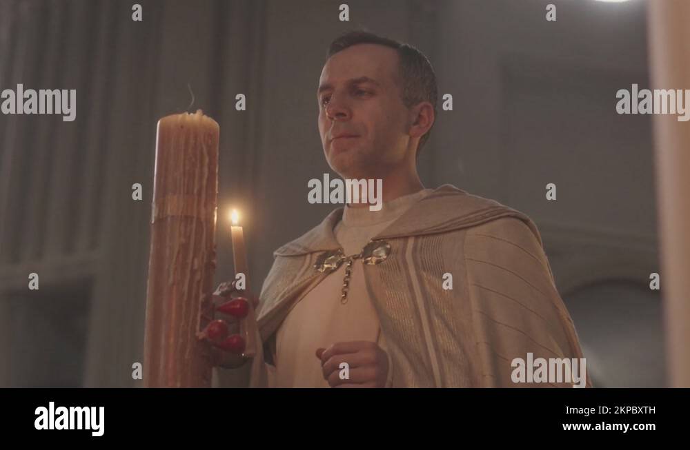 Priest Lighting Candle in Catholic Church Stock Video Footage - Alamy