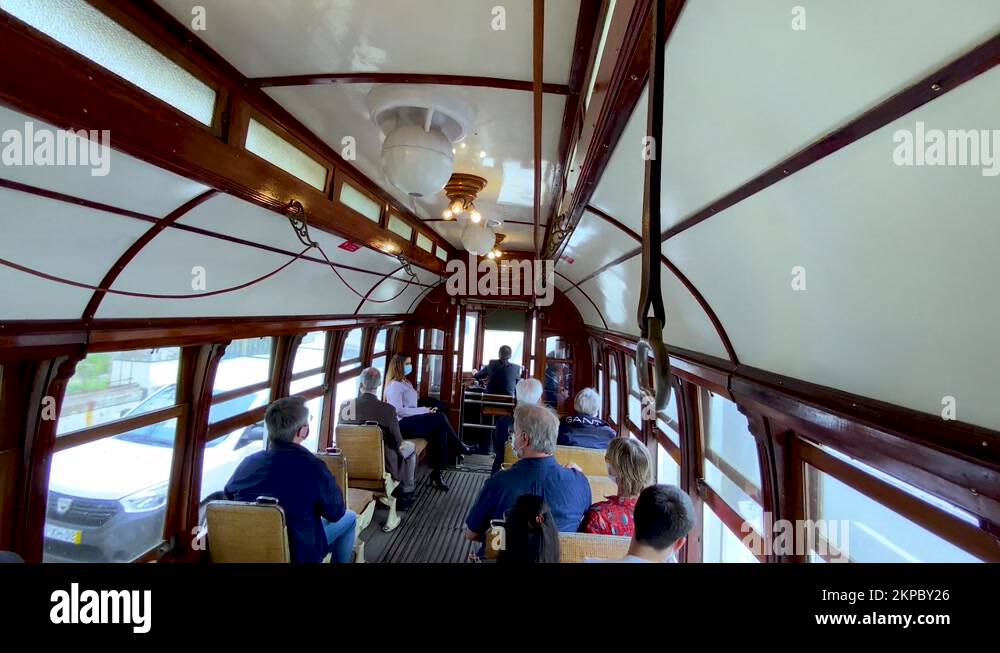 People go inside an old tram. Traveling by Porto street inside vintage ...