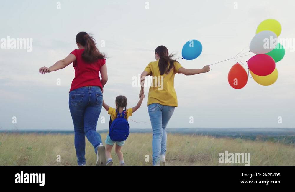 running family park. happy mother child kid run teamwork. colorful air ...