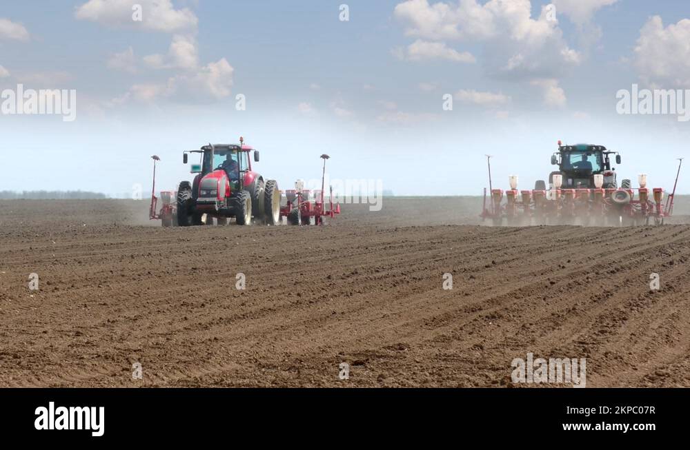 Tractors and Seeder Planting Crops on a Field Stock Video Footage - Alamy