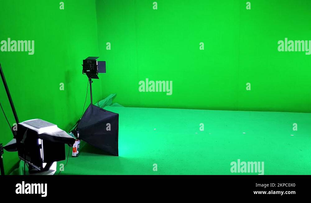 A filming studio simple setup with green screen walls and floor ...