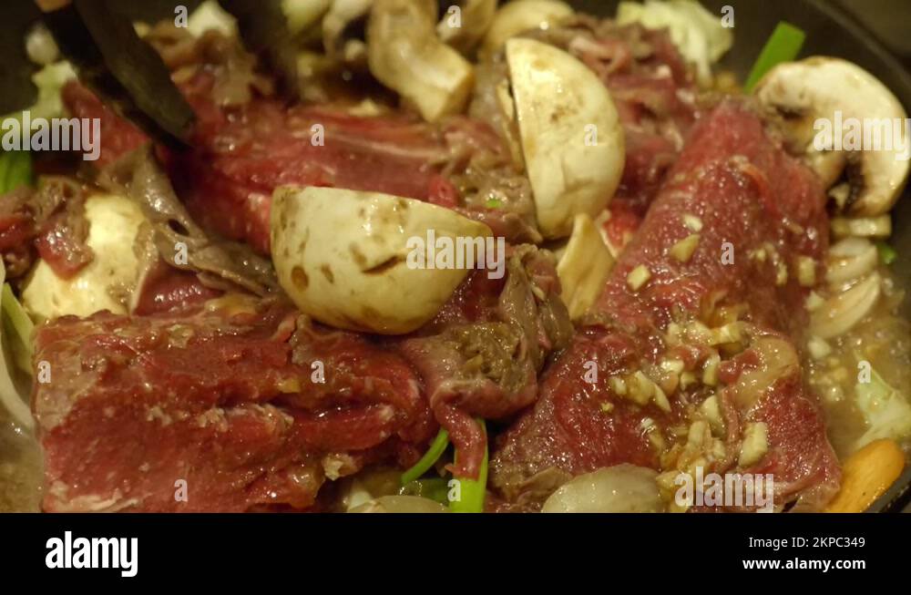 Korean Food Preparation - Person Flipping Meat In A Pot - Close up shot ...