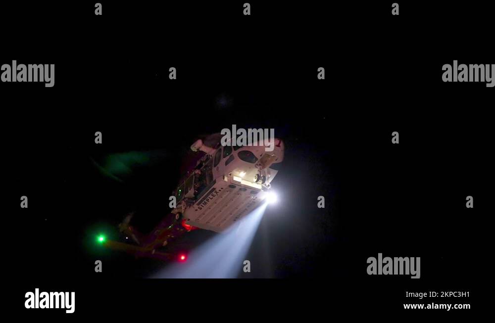 Helicopter with spotlight flying on a search and rescue mission, night ...