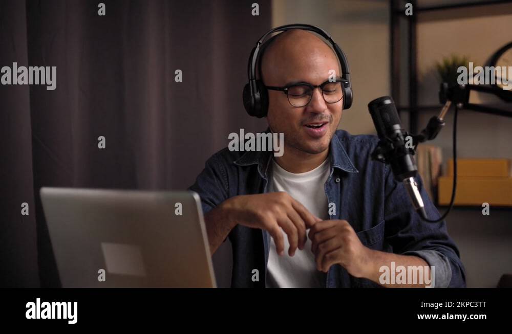 Content creator man host streaming his a podcast on laptop with ...