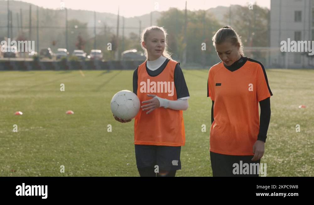 Two female soccer player walking and talking after training Stock Video ...