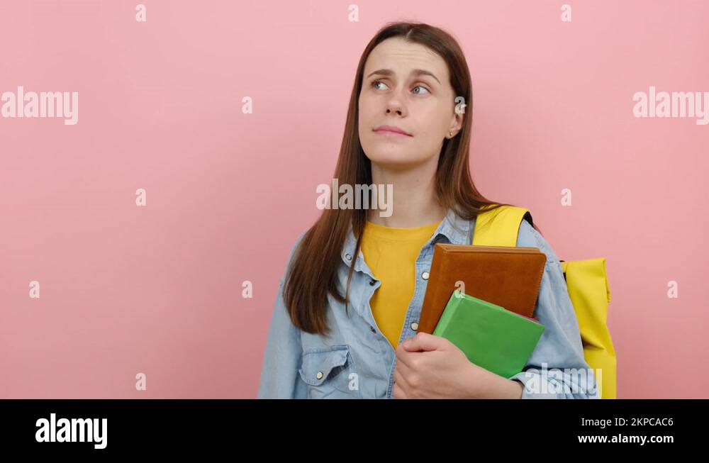 Puzzled pensive girl teen student holding question marks and books ...
