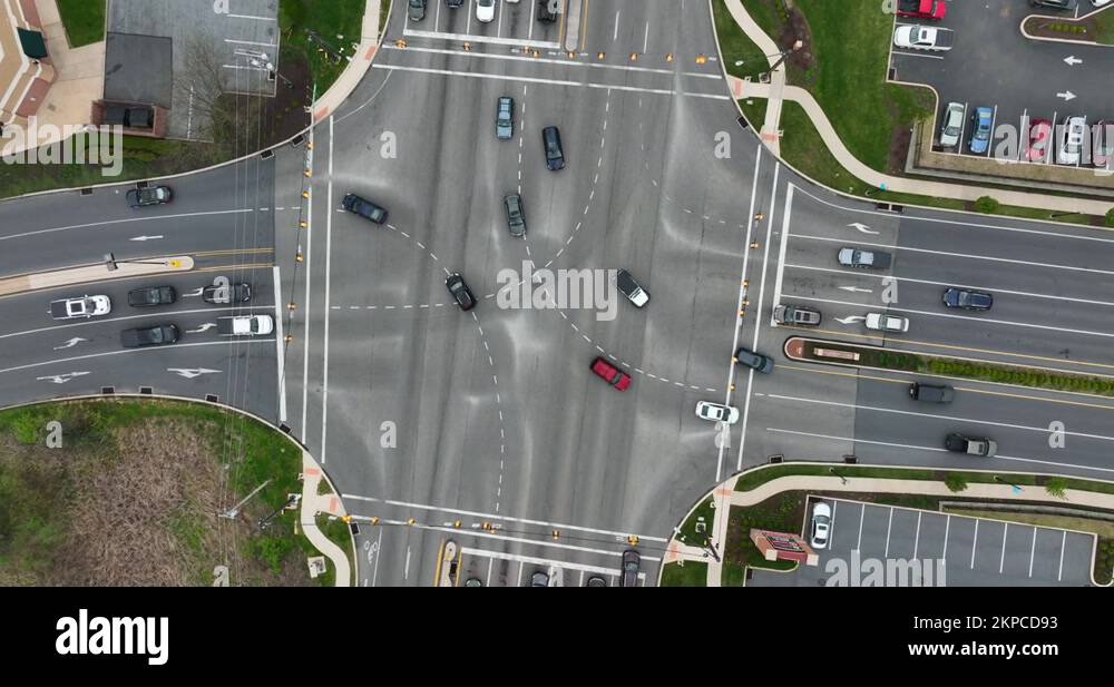 Confusing multilane traffic intersection with cars crossing lanes. Top ...