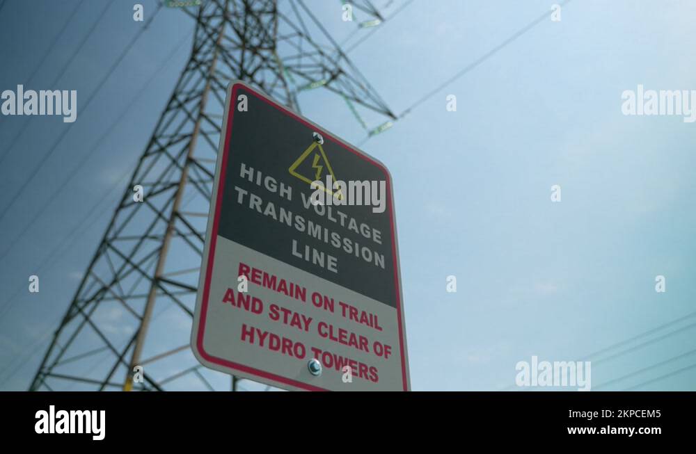 Warning sign in front of hydroelectric tower. Hazardous. Slow wrap ...