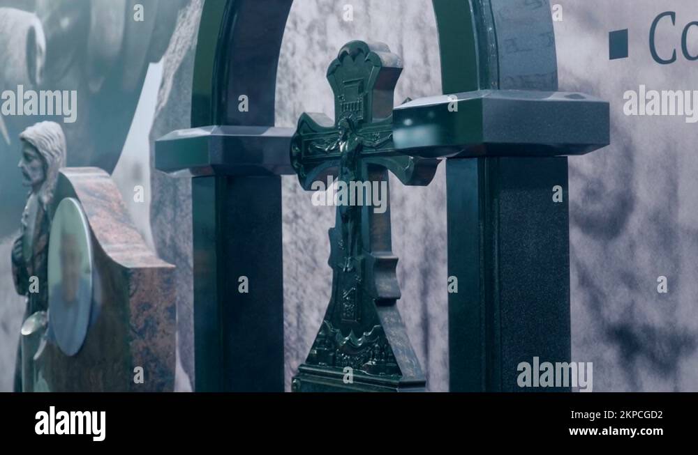 Black polished granite tombstone cross with the crucified figure of Jesus Christ Stock Video ...