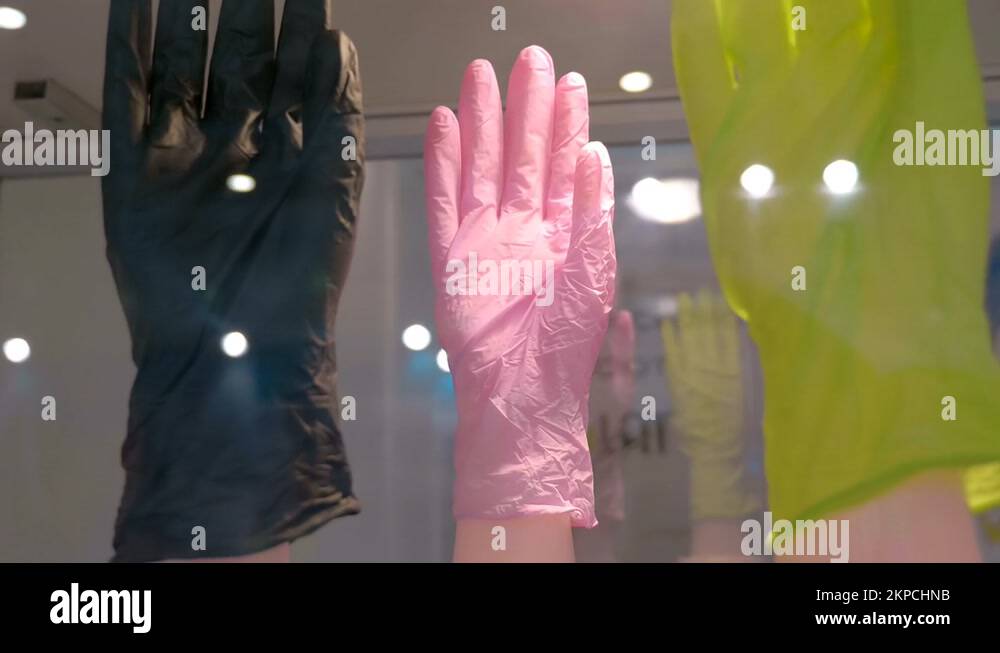 Sterile new medical gloves in different colors are presented on glass ...