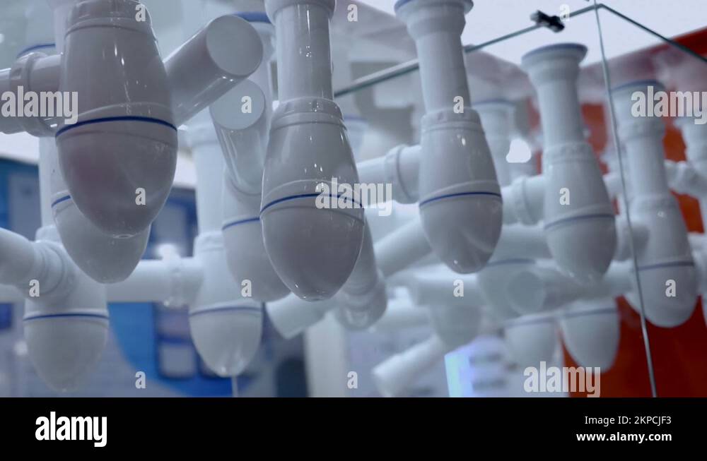 Beautiful, shiny, white modern siphon system for draining water from ...