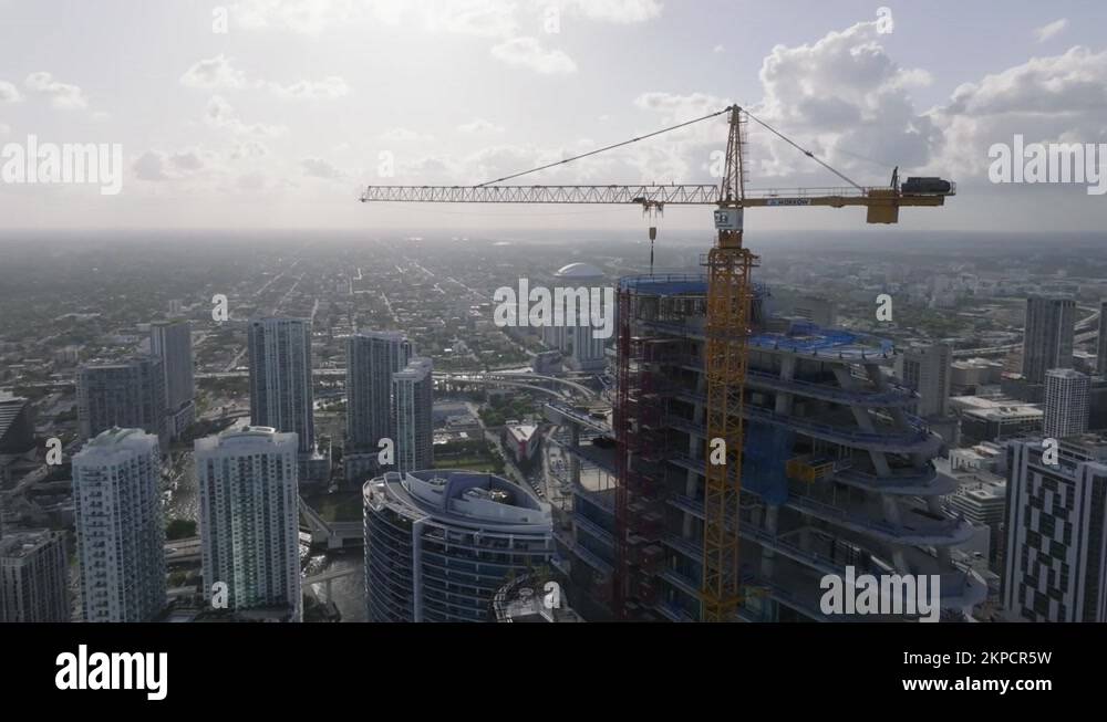 alt flying counter clockwise around construction crane atop skyscraper in Miami Stock Video ...