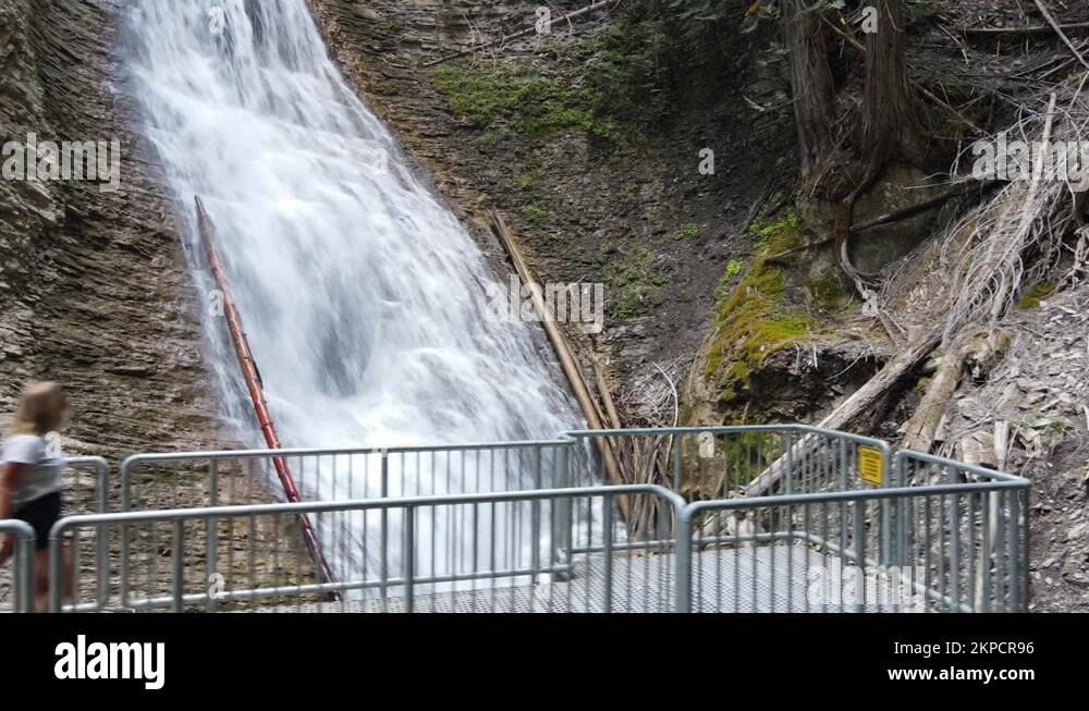 Young female hiker crossing a bridge at the bottom of the stunning ...