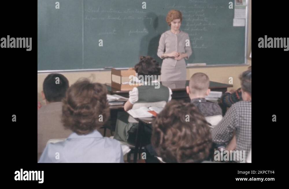 1960s: Woman teaching students. Teacher lecturing to classroom. Boy ...