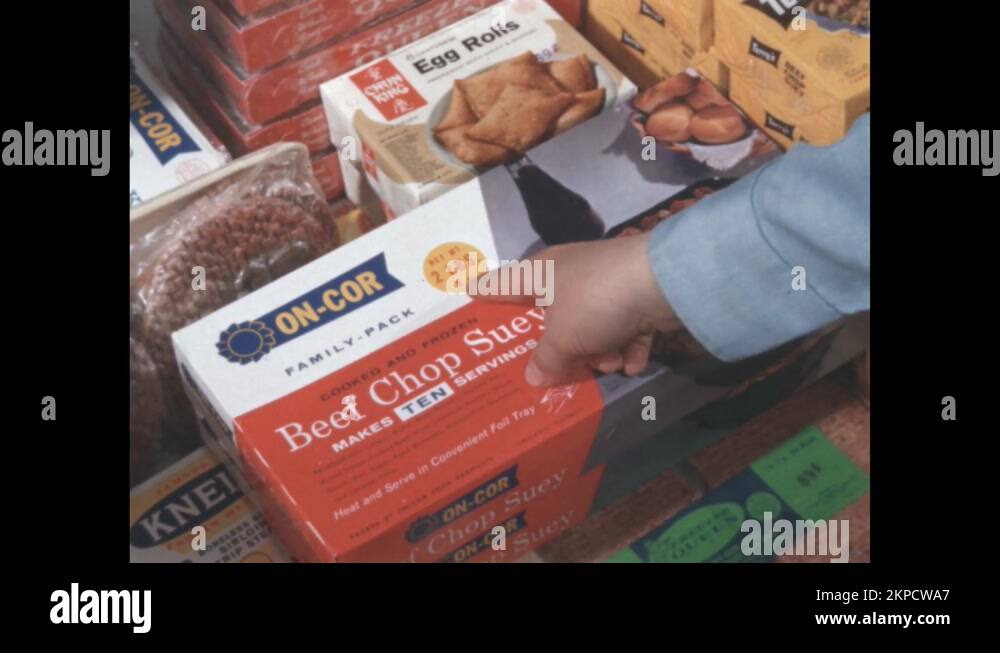 1960s: Boy points at frozen beef chop suey in freezer case at grocery ...