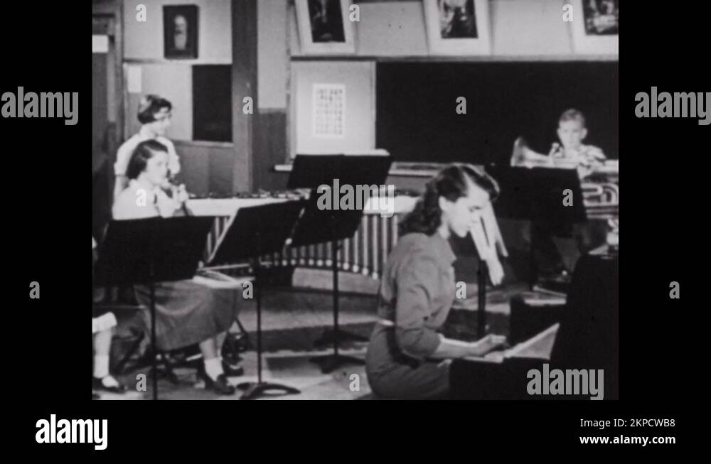 1950s: Girl plays marimba with mallets. Teacher plays piano and the ...